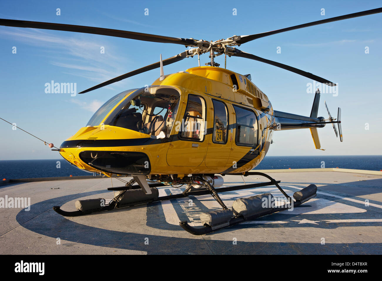 A Bell 407 utility helicopter on the helipad of an oil rig Stock Photo ...