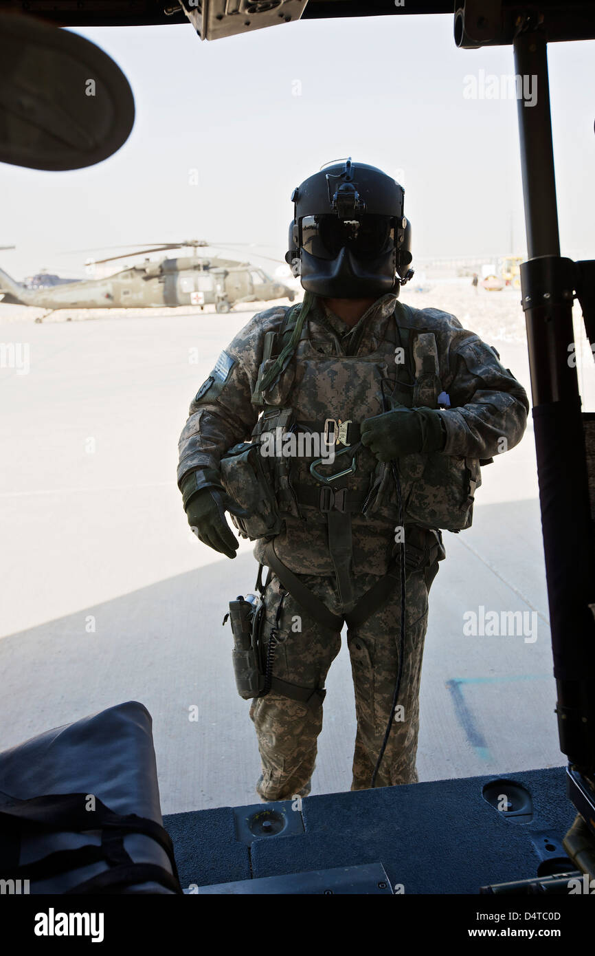 U.S. Army UH-60L Loadmaster confirms pre-fliight check on his aircraft ...