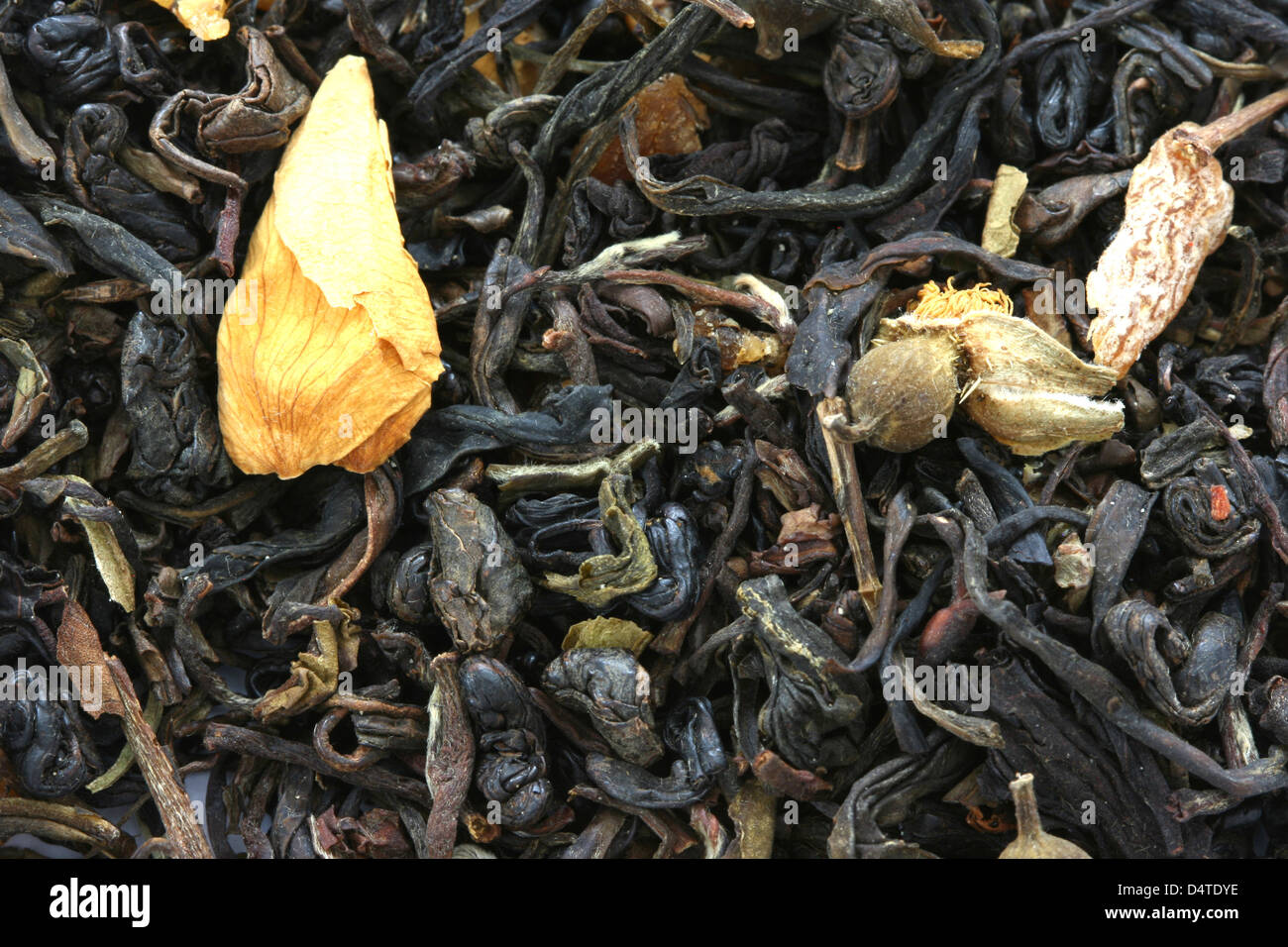 Dry black tea flavored with dry flower buds background Stock Photo - Alamy