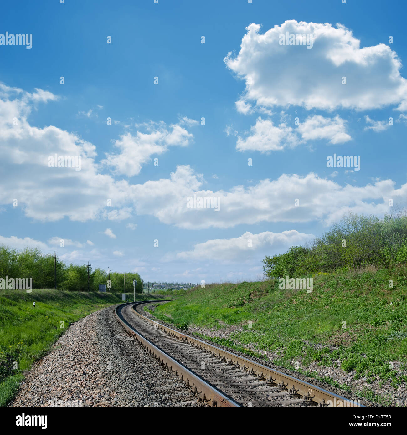 railway goes to horizon in green landscape Stock Photo - Alamy