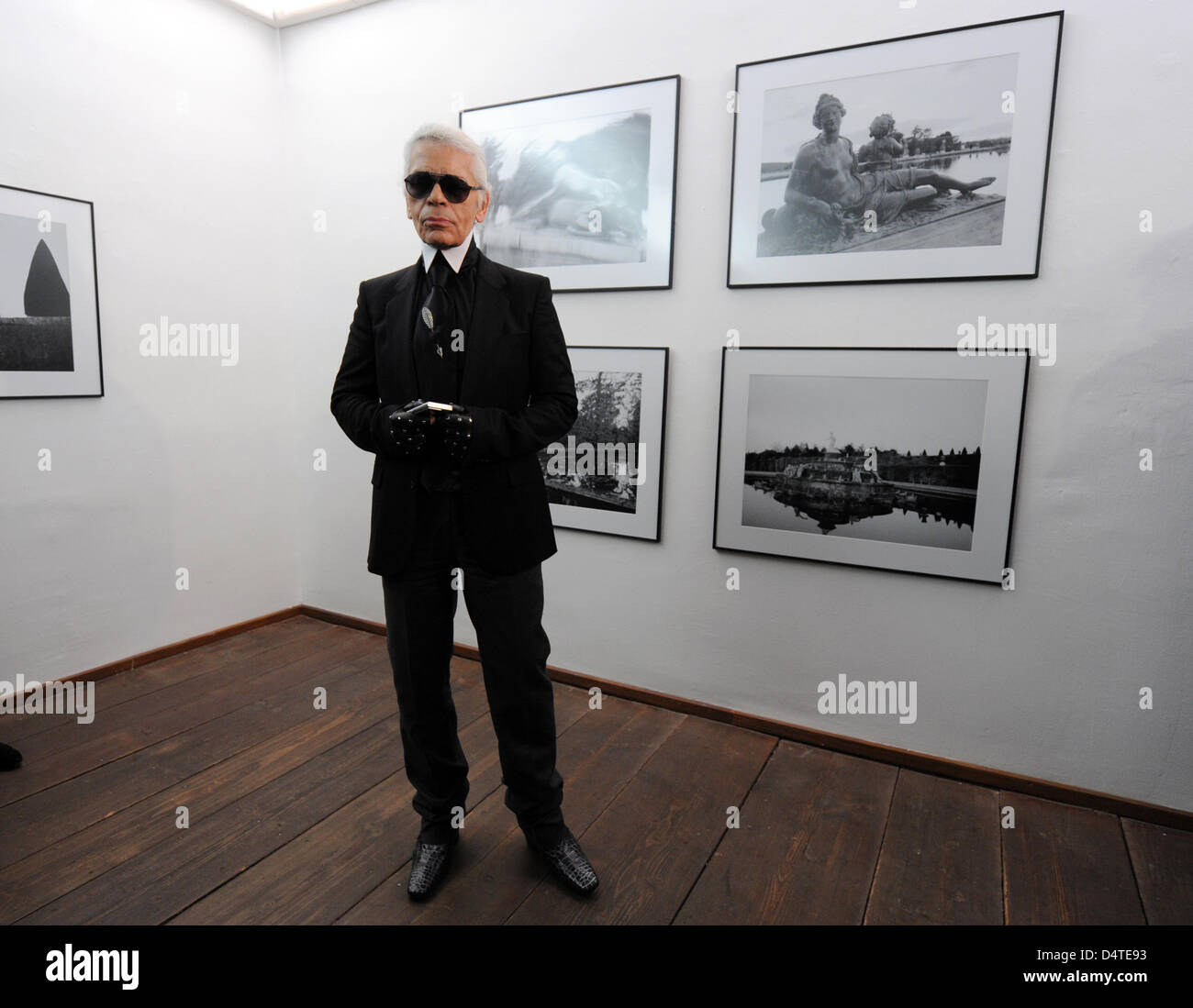 German fashion designer Karl Lagerfeld stands in front of photos in his ...