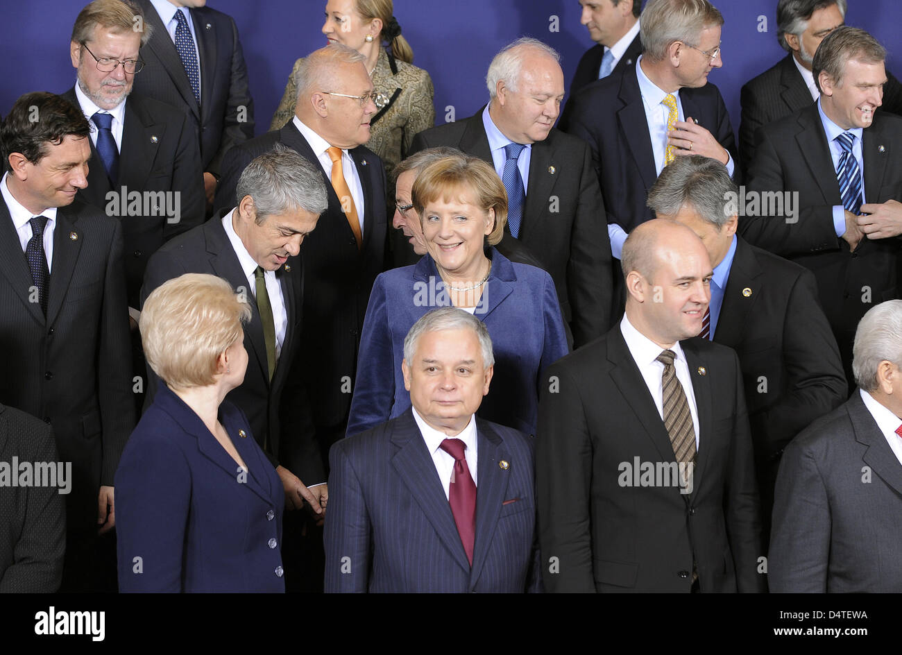 German Chancellor Angela Merkel stands in between her colleagues during ...
