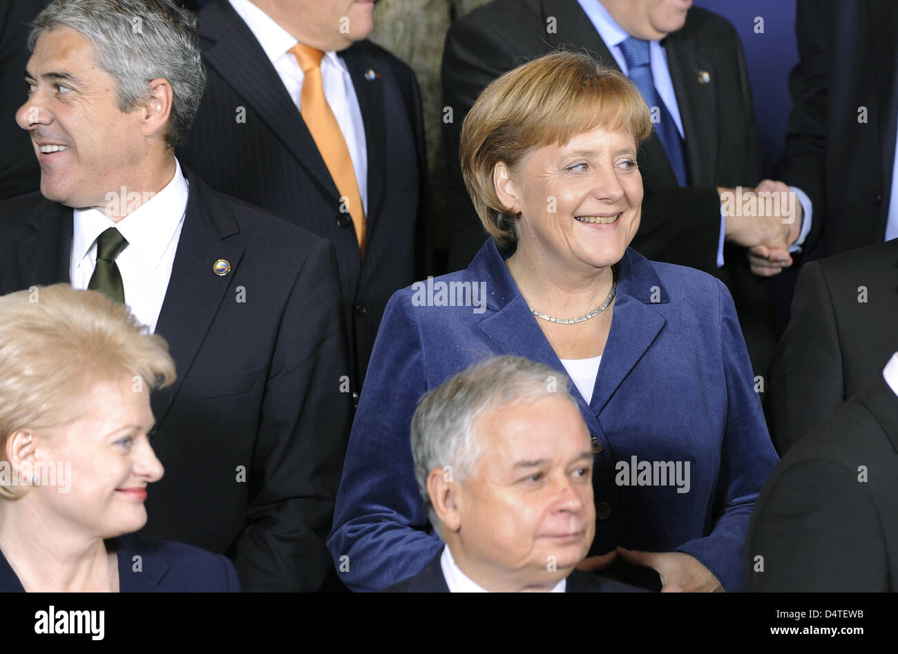 German Chancellor Angela Merkel stands in between her colleagues during ...