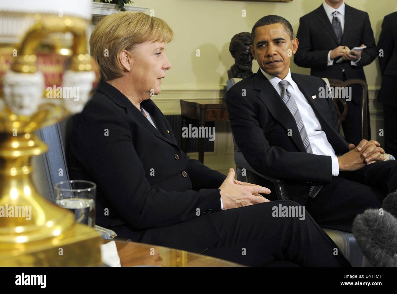 US President Barack Obama and German Chancellor Angela Merkel talk at a ...