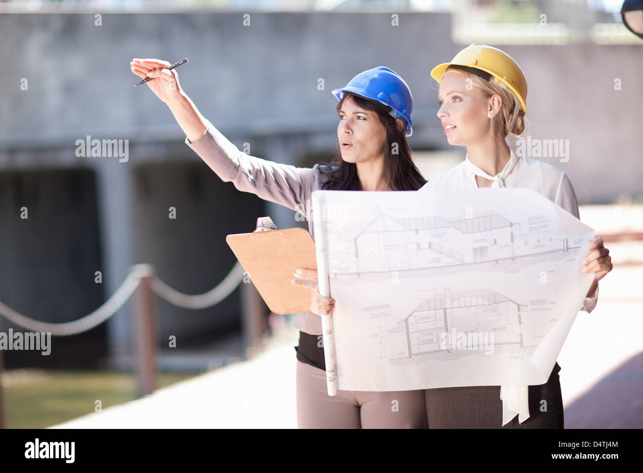 Female construction worker reading blueprints hi-res stock photography ...