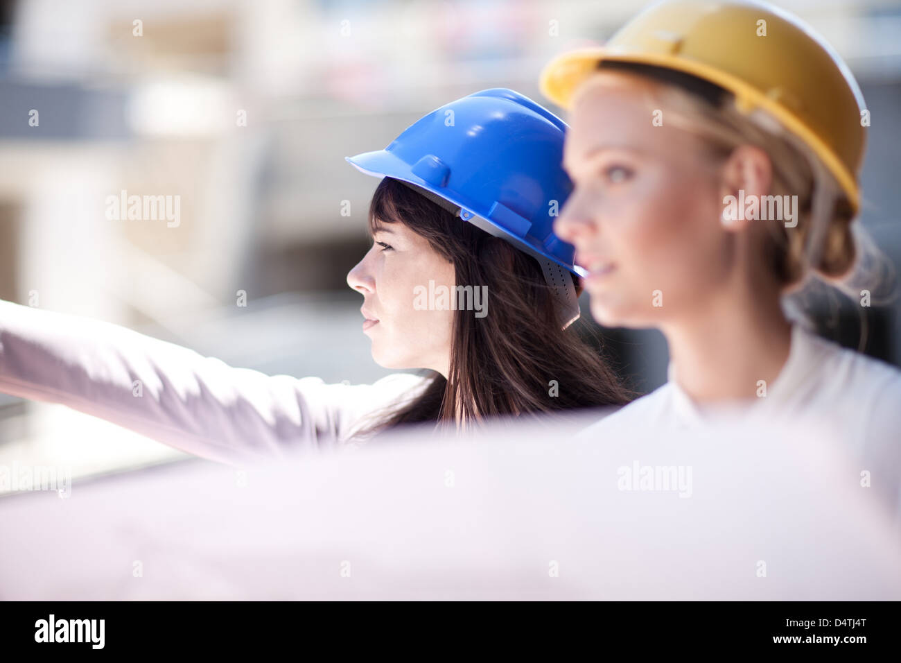 Female construction worker reading blueprints hi-res stock photography ...