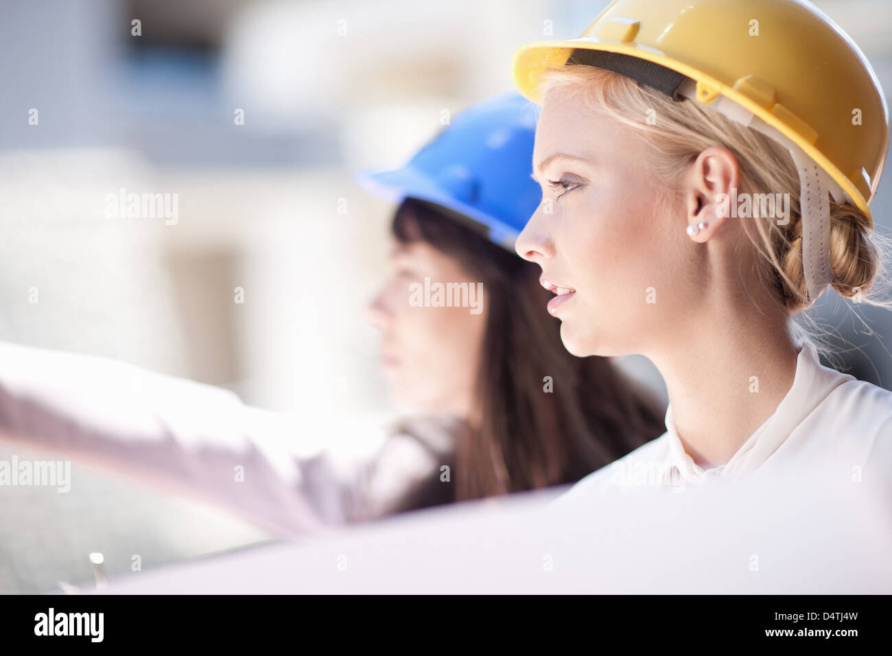 Female construction worker reading blueprints hi-res stock photography ...
