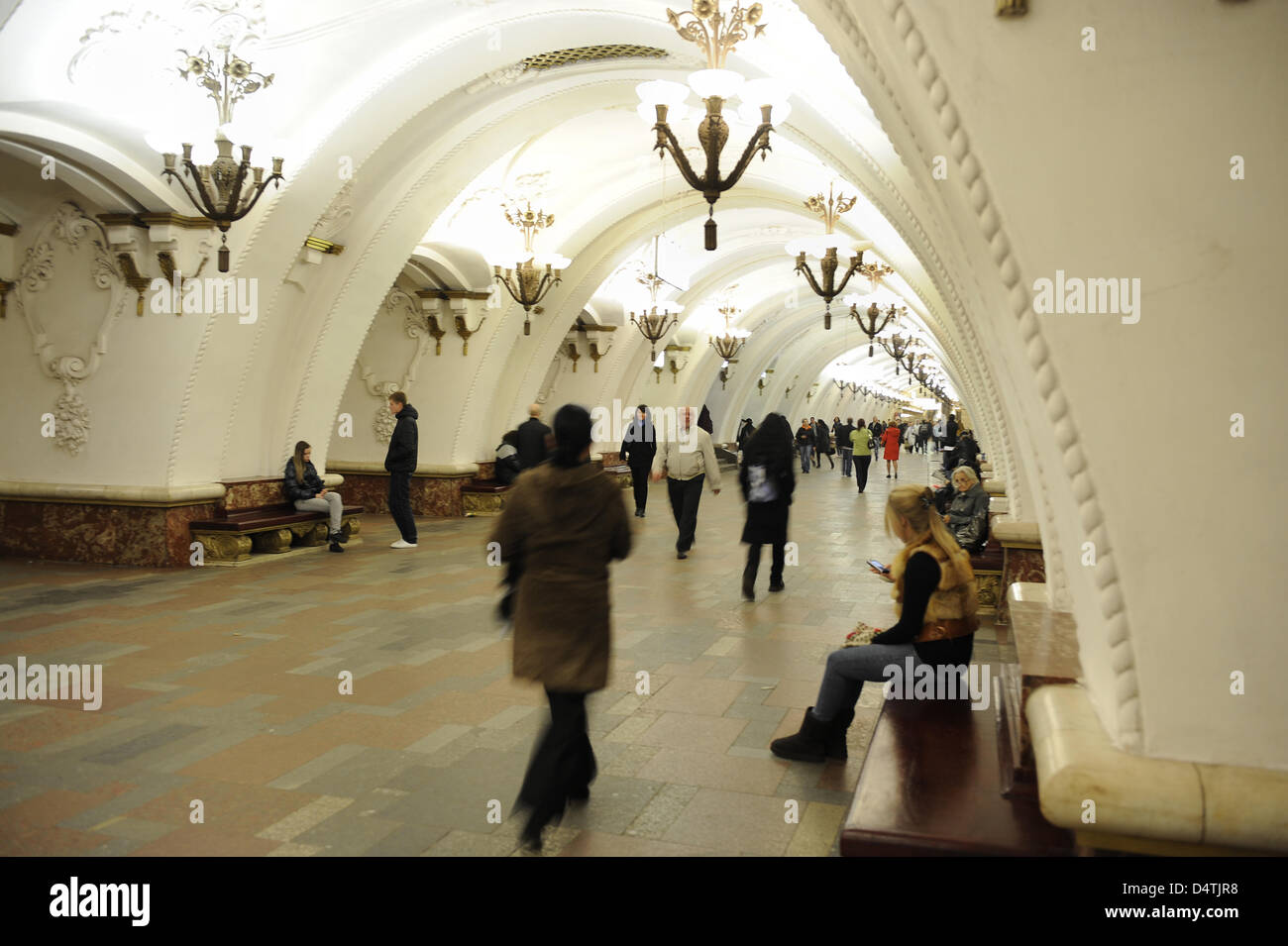 Passengers inside richly ornamented Arbatskaya metro station in Moscow ...