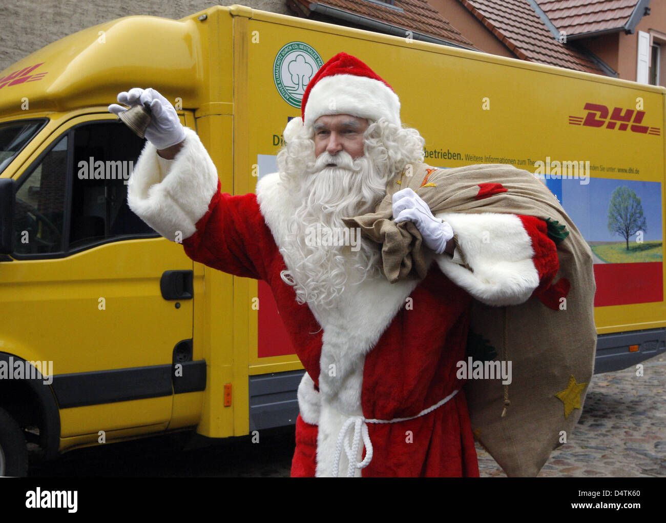 Santa Claus poses in front a post van during the opening of christmas ...
