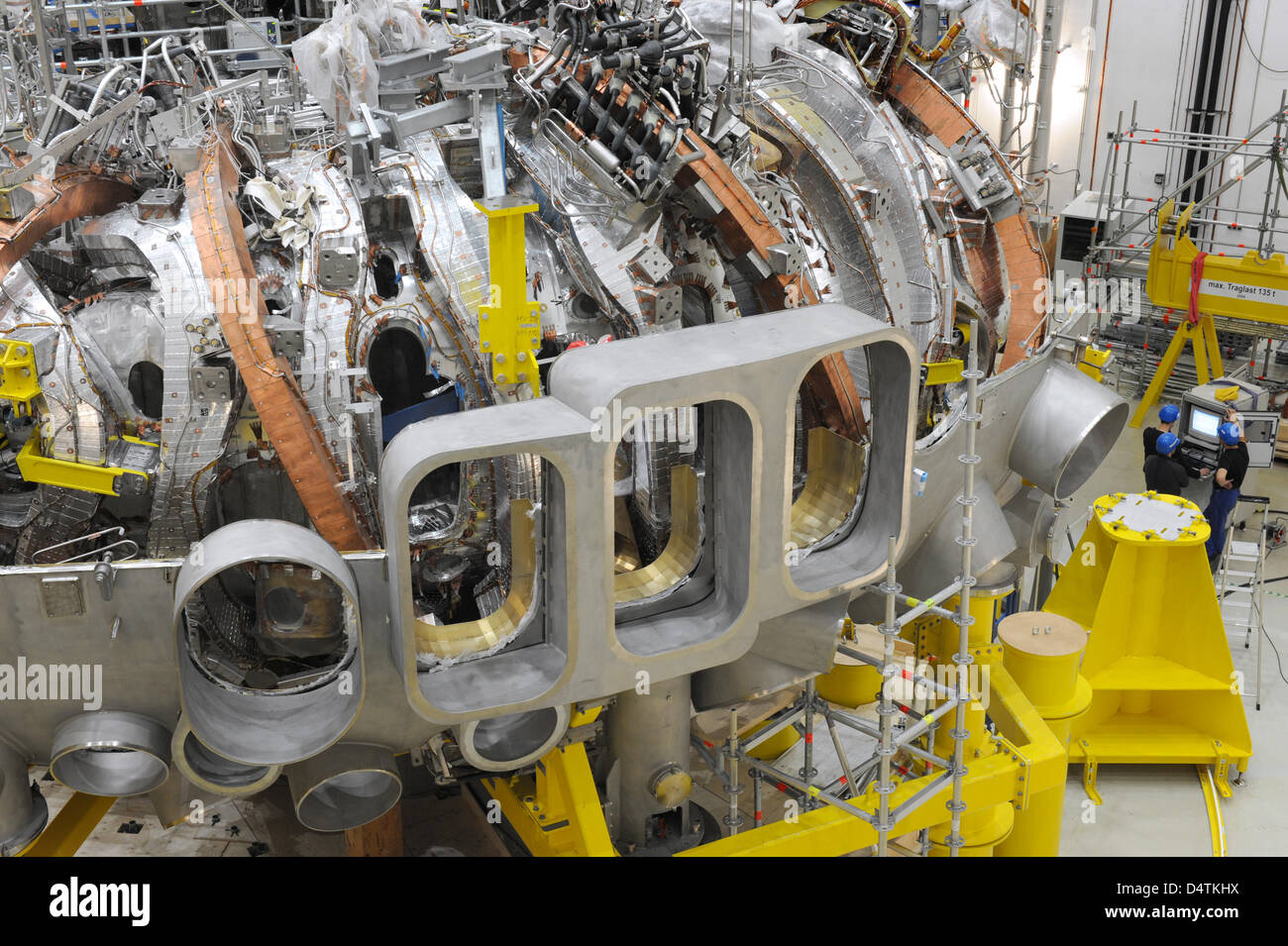 Staff members of the Max-Planck-Institute for plasma physics work at a ...