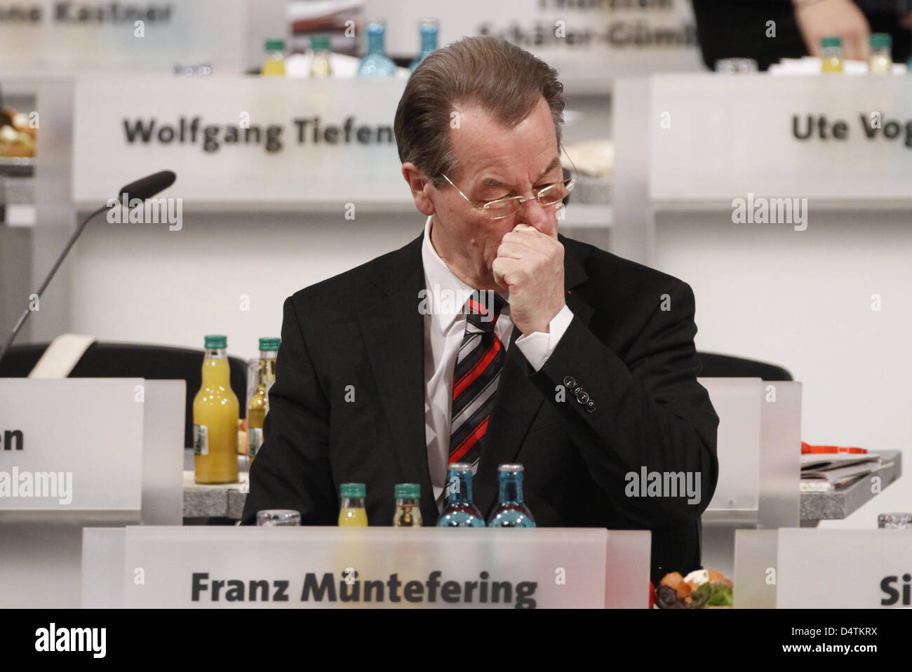 Outgoing SPD leader Franz Muentefering touches his face during the ...