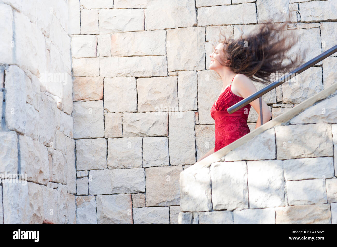 Woman climbing stone steps outdoors Stock Photo - Alamy