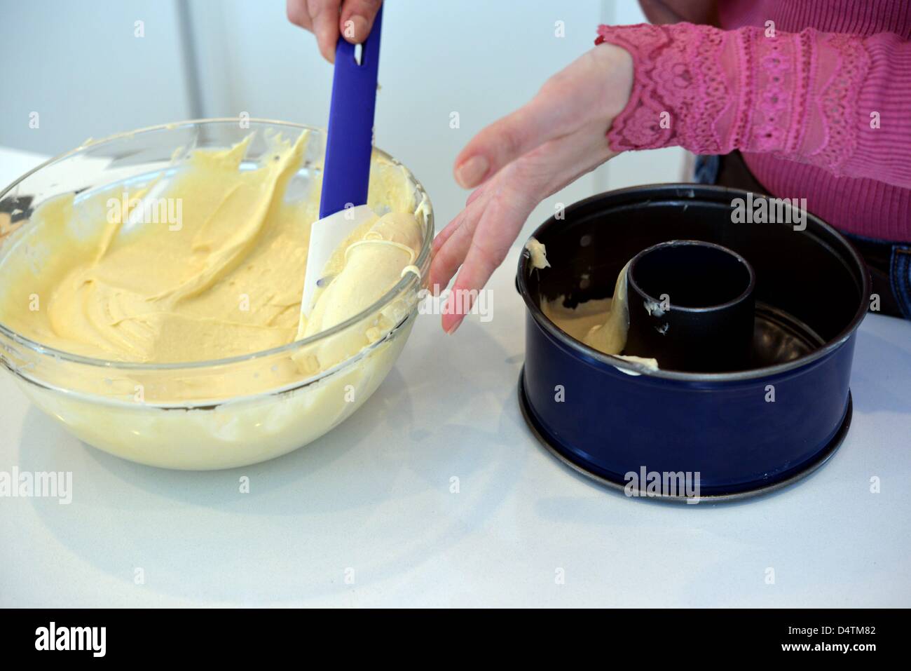 Preparing a cake in a kitchen. Photo: Frank May Stock Photo - Alamy