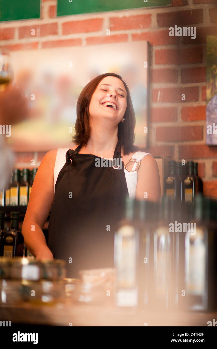 Server laughing in grocery store Stock Photo - Alamy