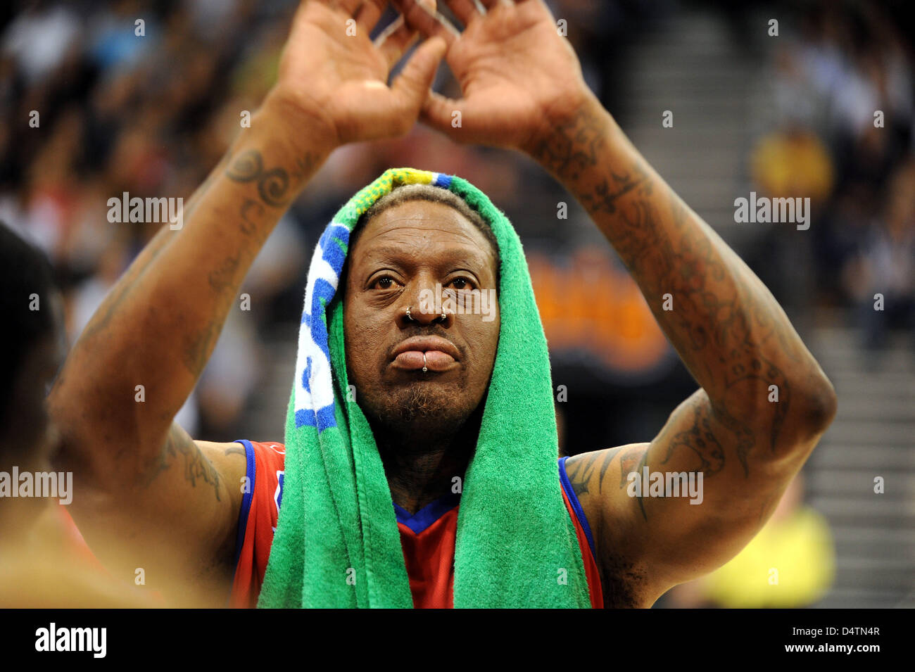Former NBA star Dennis Rodman greets the audience during a basketball ...