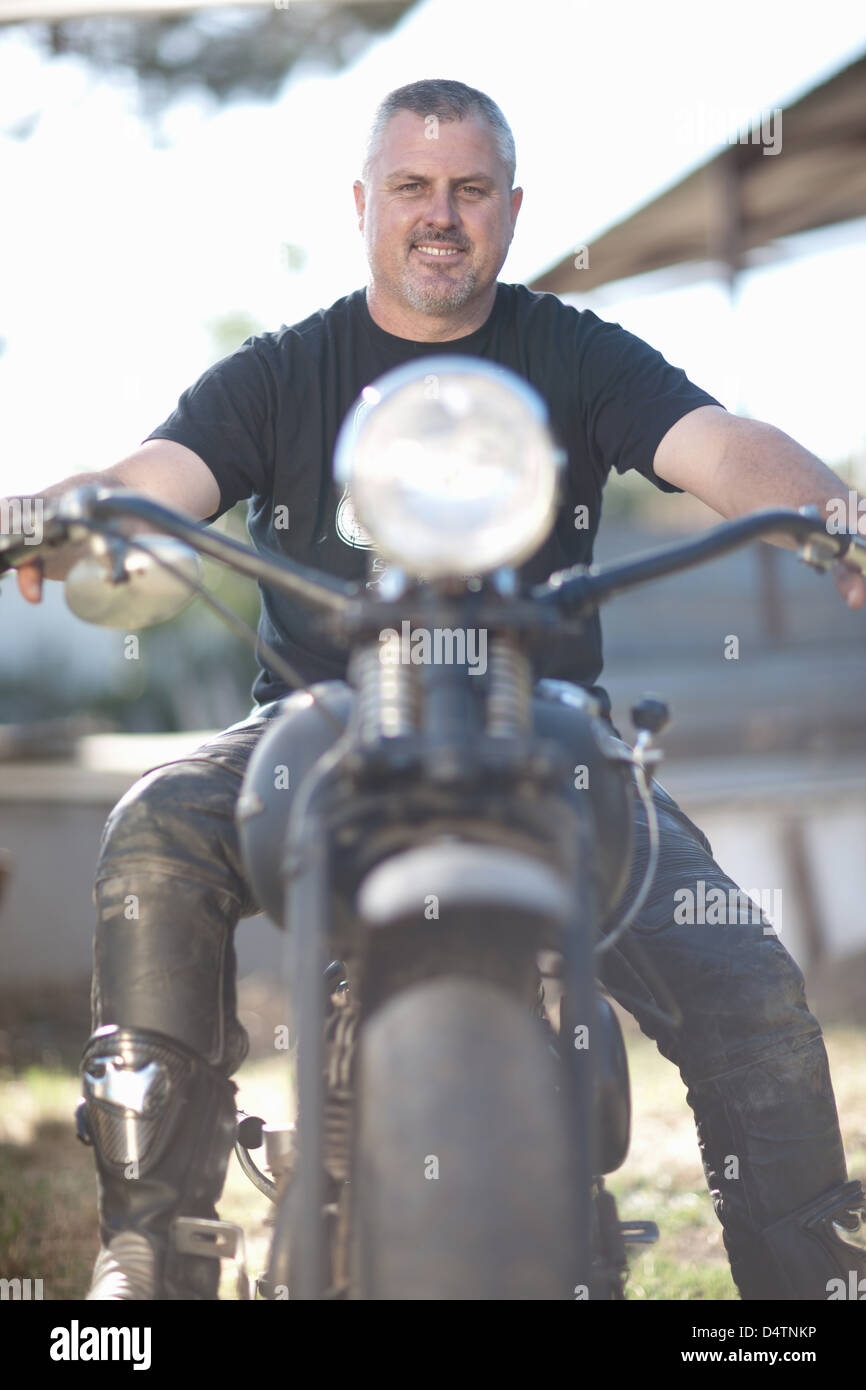 Man sitting on motorcycle Stock Photo - Alamy