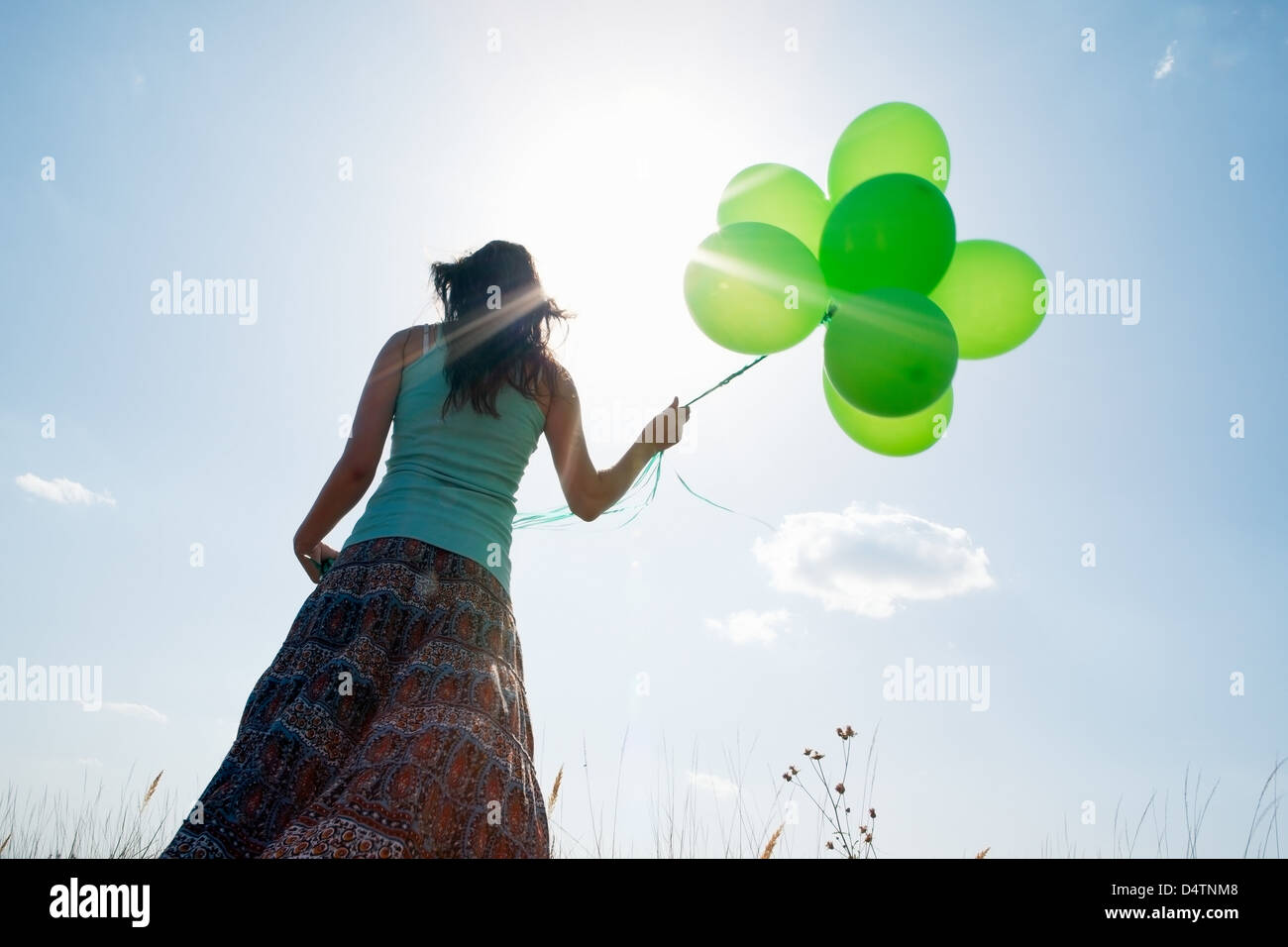 Woman carrying bunch of balloons Stock Photo - Alamy