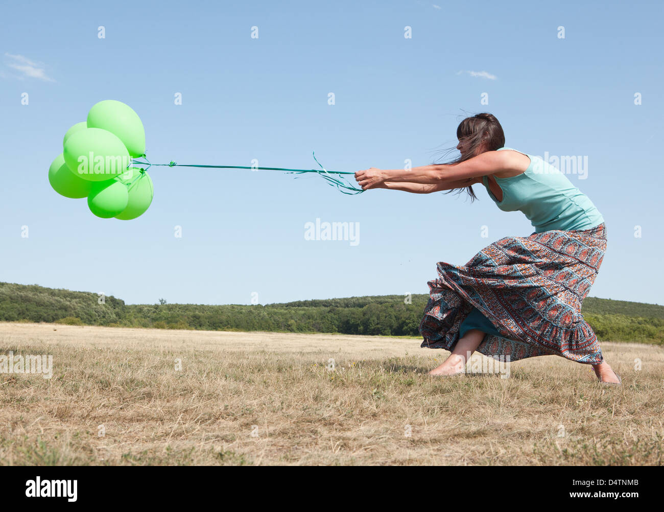 Woman carrying bunch of balloons Stock Photo - Alamy