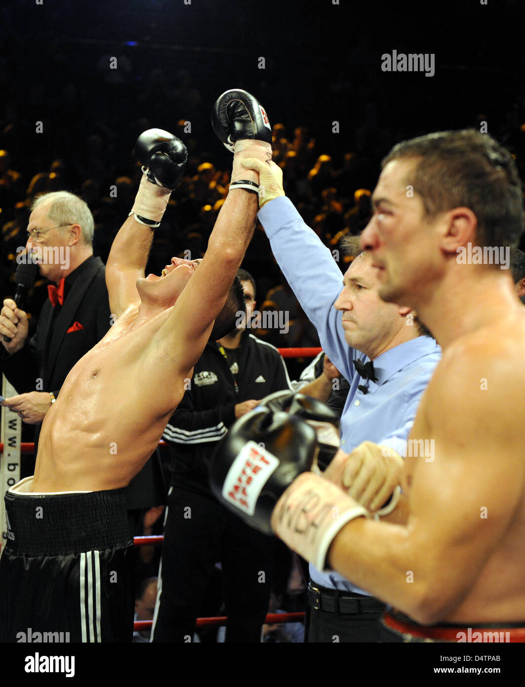 German boxer Dimitri Sartison (2-L) celebrates his victory in the WBA ...