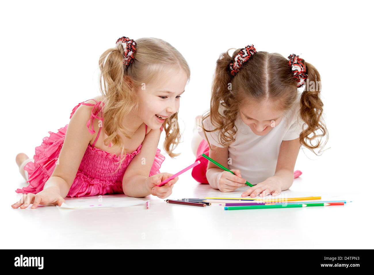 two girls drawing with color pencils together over white Stock Photo ...