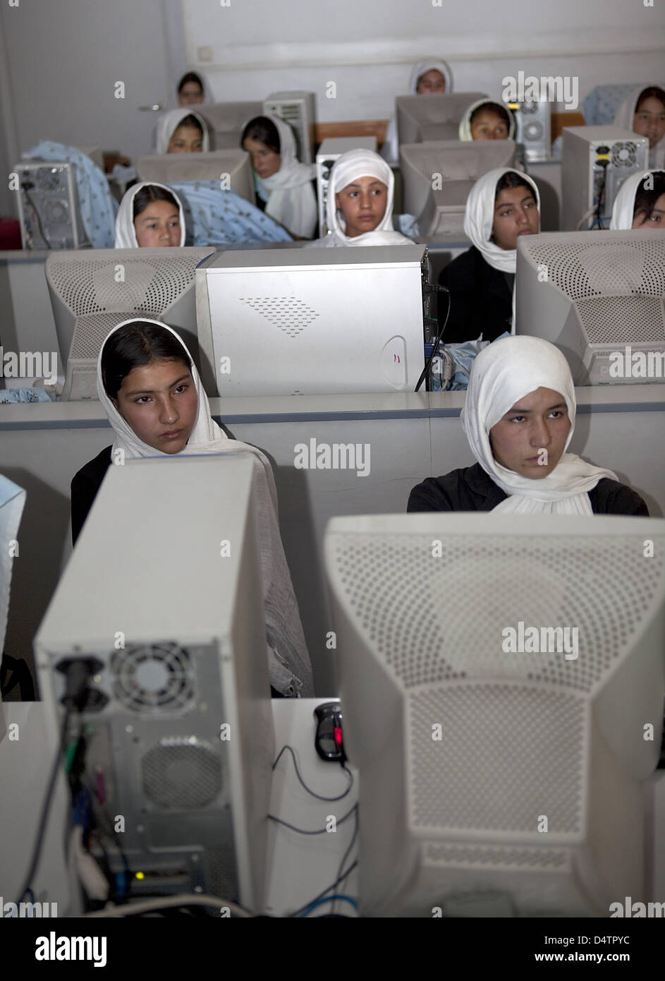 Afghan girls wearing headscarves attend a computer sciences lesson at ...