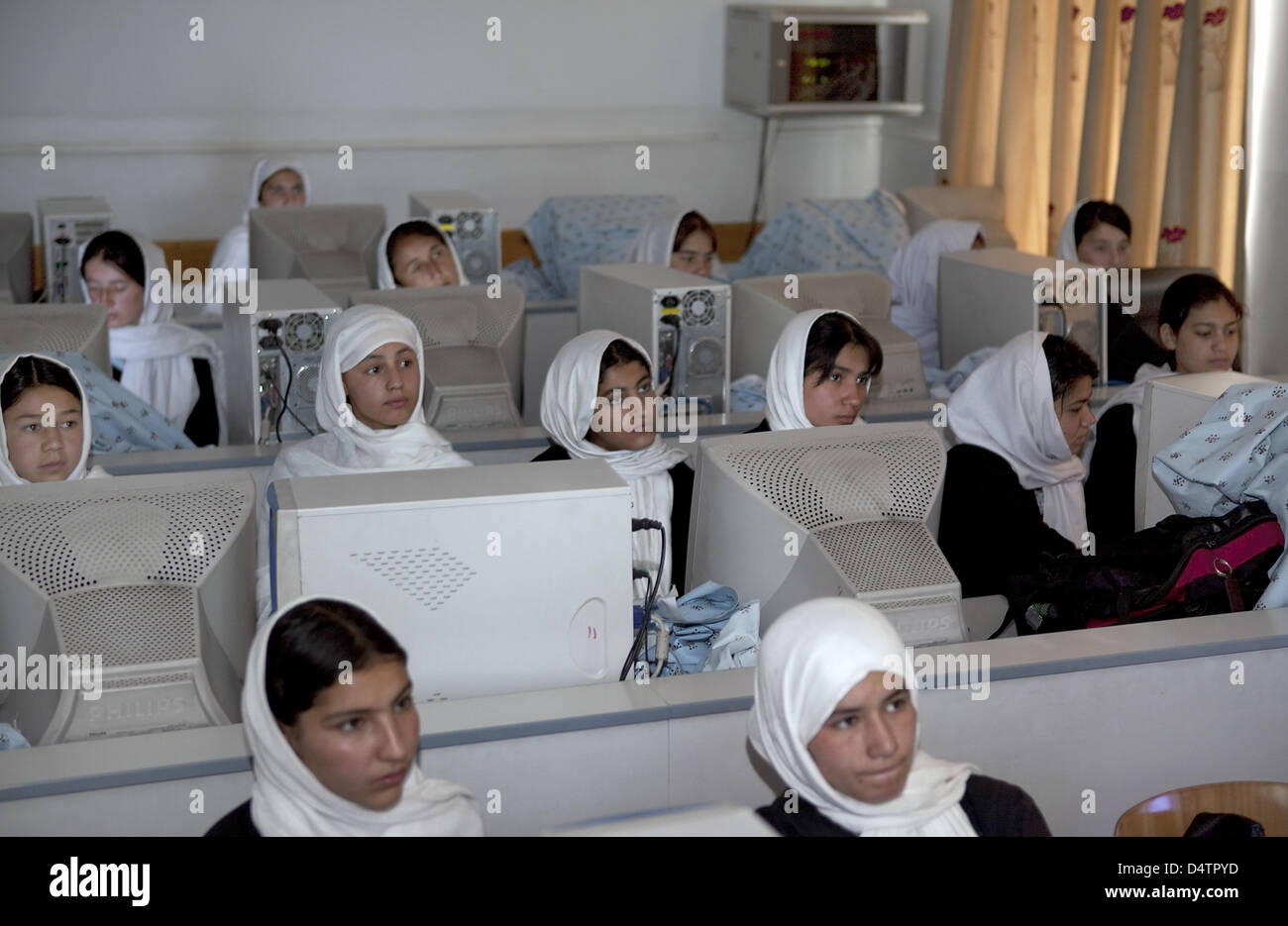 Afghan girls wearing headscarves attend a computer sciences lesson at ...