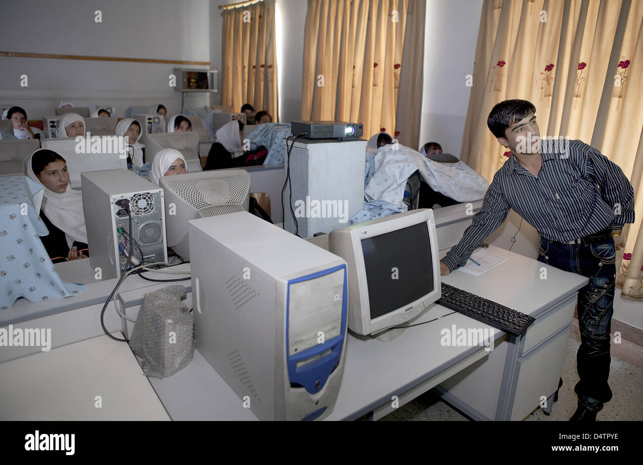 Afghan girls wearing headscarves attend a computer sciences lesson at ...