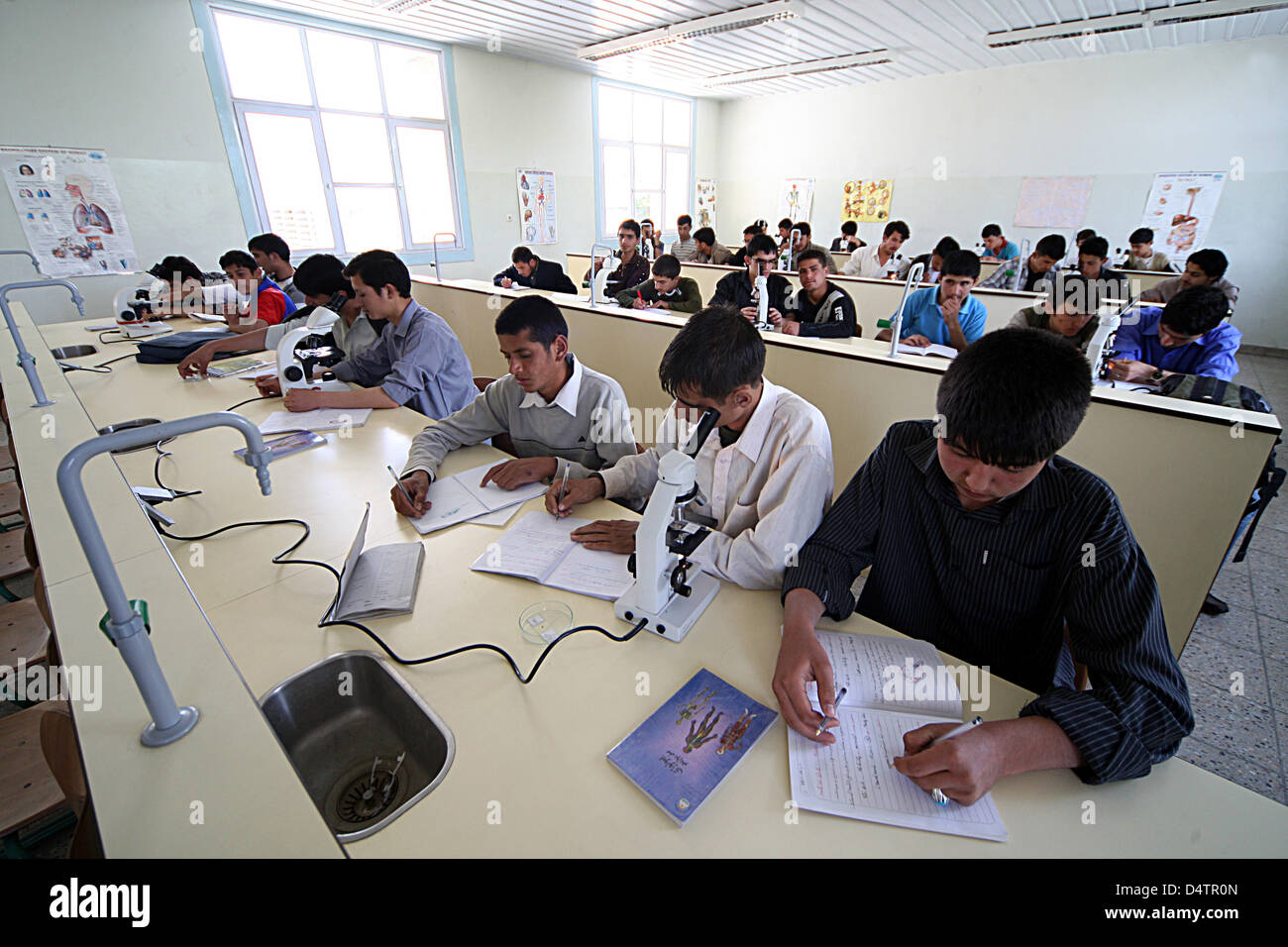 Afghan boys attend a chemistry lesson at Amani High School in Kabul ...