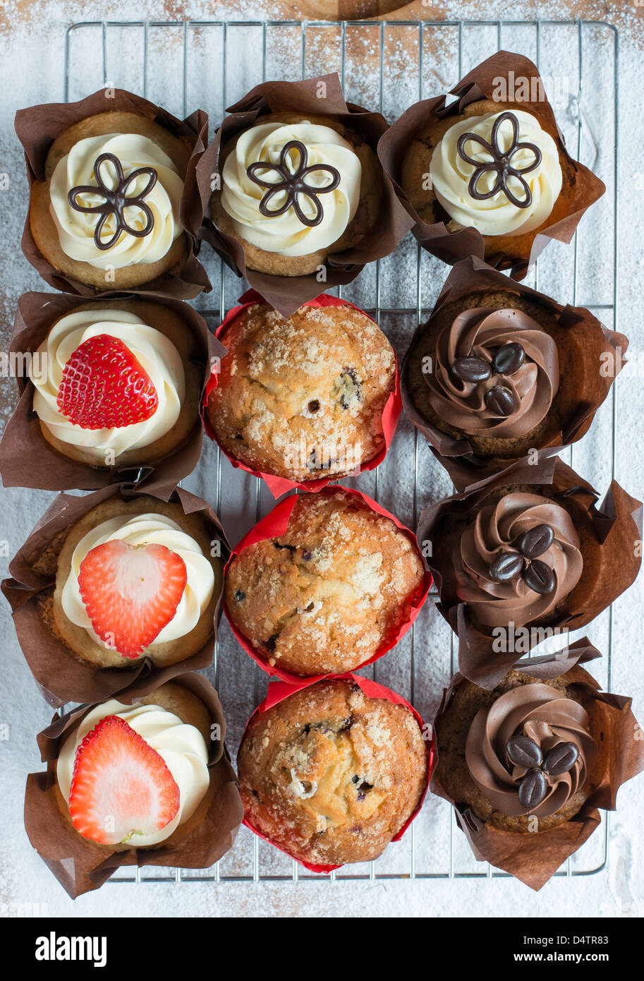 A colourful neat selection of muffins and cupcakes Stock Photo - Alamy
