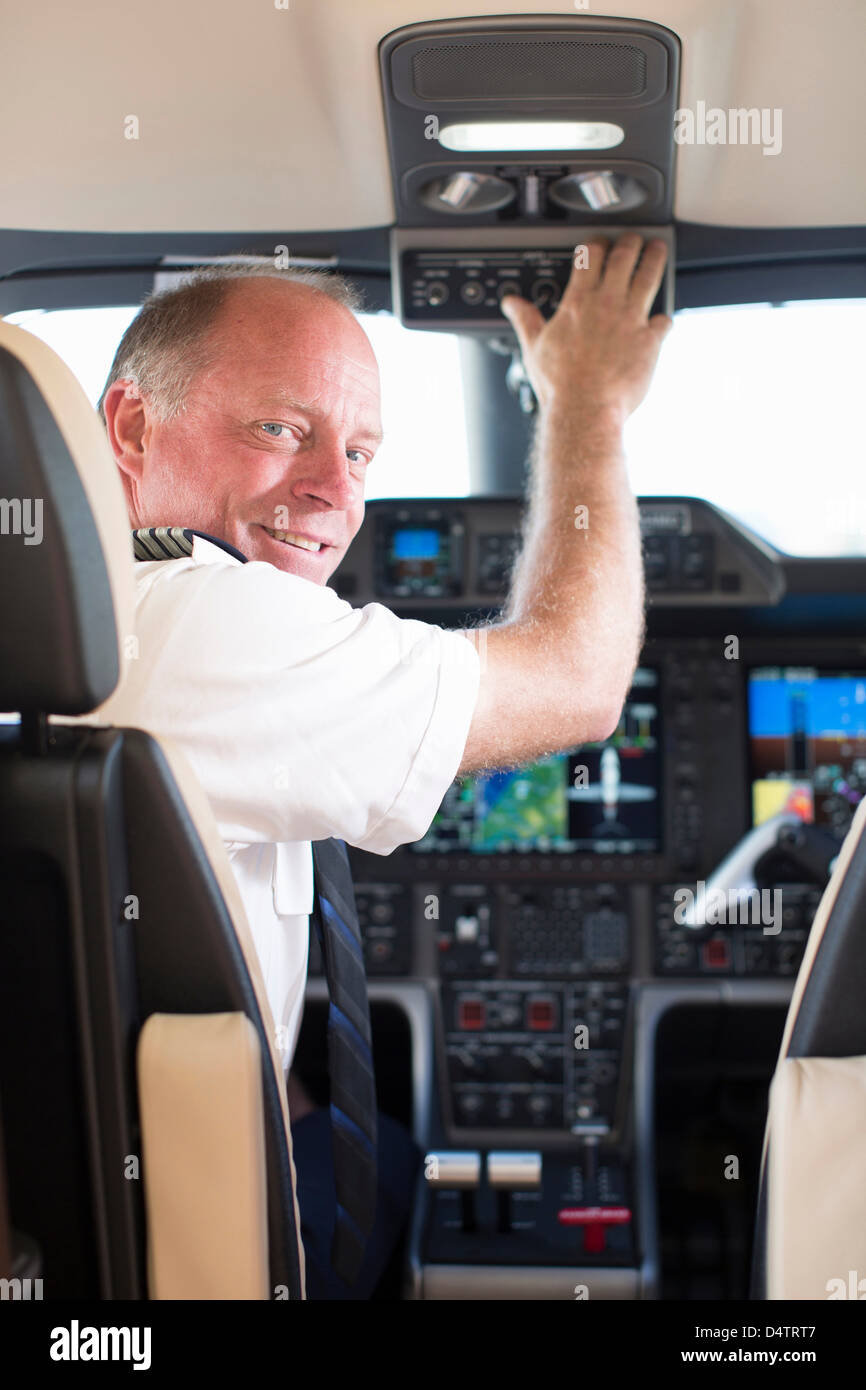 Pilot smiling in airplane cockpit Stock Photo - Alamy