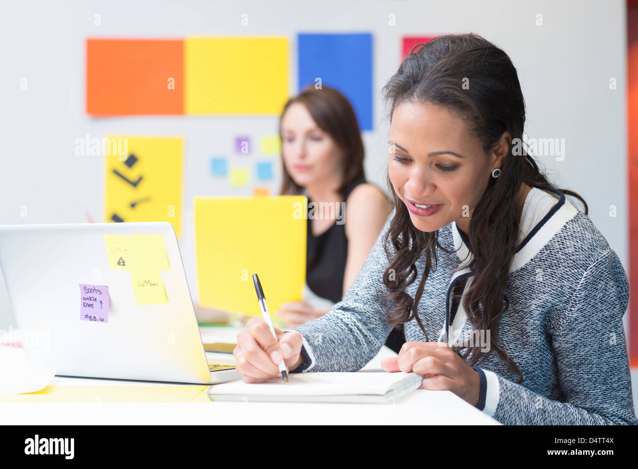 Female sitting desk taking notes hi-res stock photography and images ...