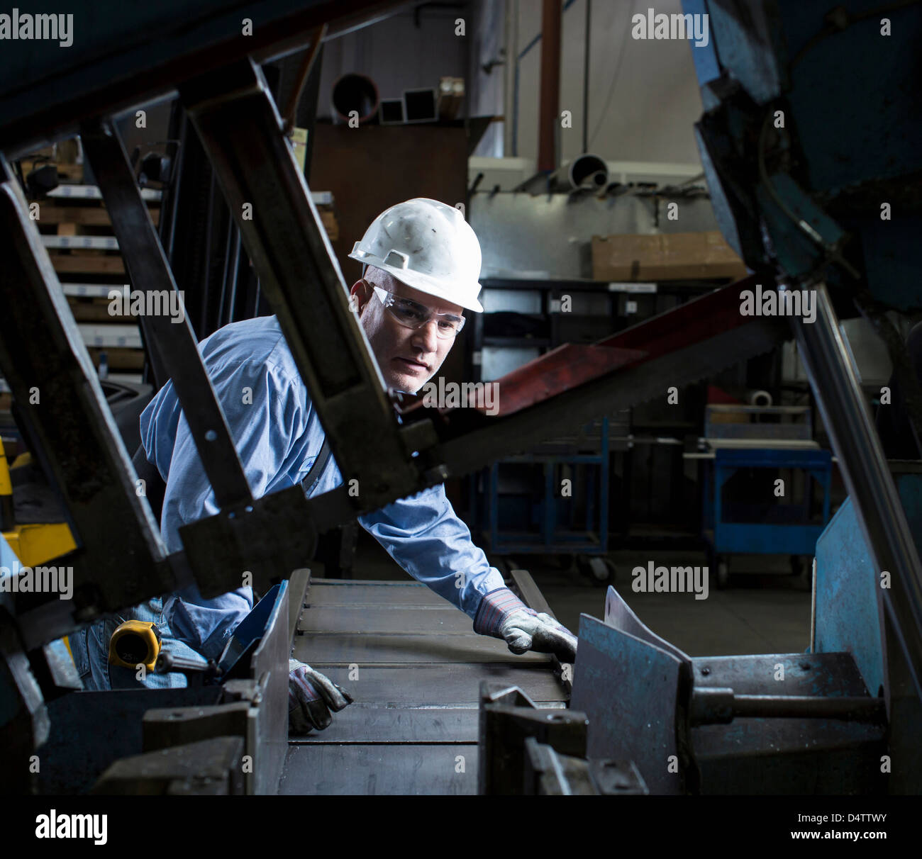 Worker using machinery in metal plant Stock Photo - Alamy