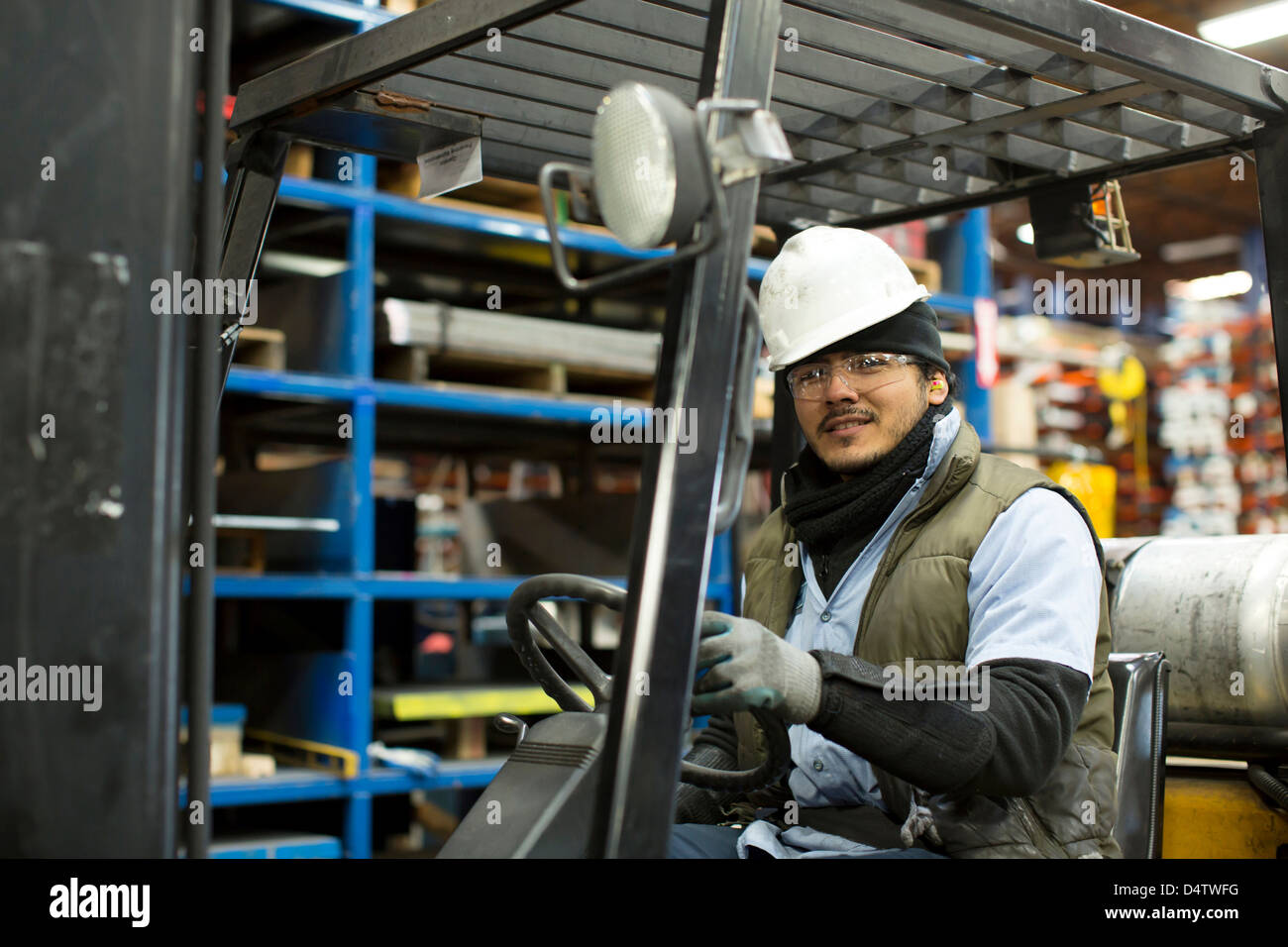 Factory warehouse worker operating machine hi-res stock photography and ...