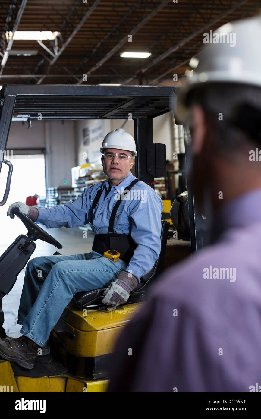 Operating forklift in warehouse worker hi-res stock photography and ...