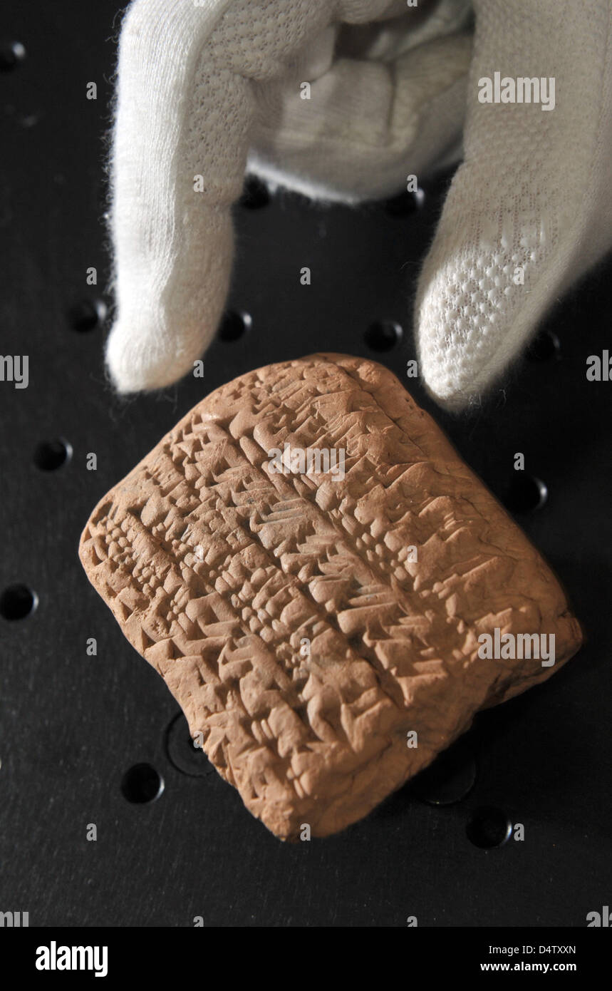 A 3700-year-old clay tablet with cuneiform inscriptions is prepared for ...