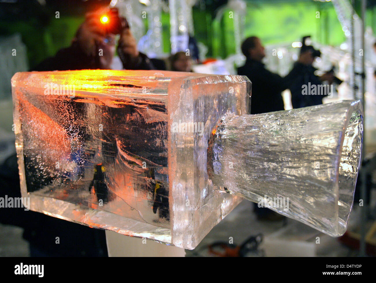 A photographer takes a picture of a camera made from ice in a cold ...