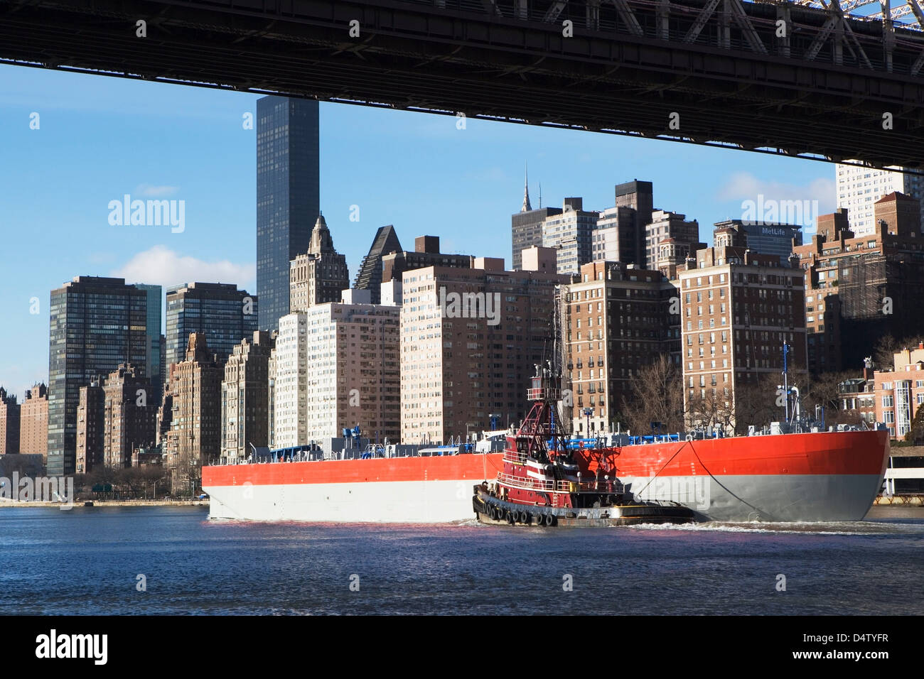 Barge under New York City bridge Stock Photo - Alamy