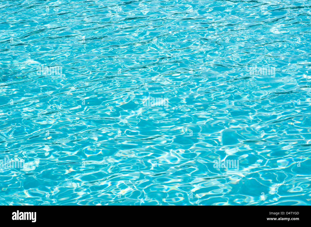 Blue pool water with sun reflections Stock Photo - Alamy