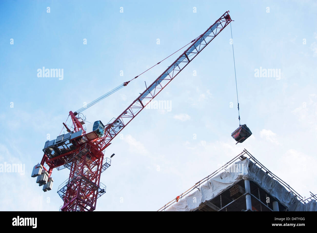 Crane loading equipment on building Stock Photo - Alamy