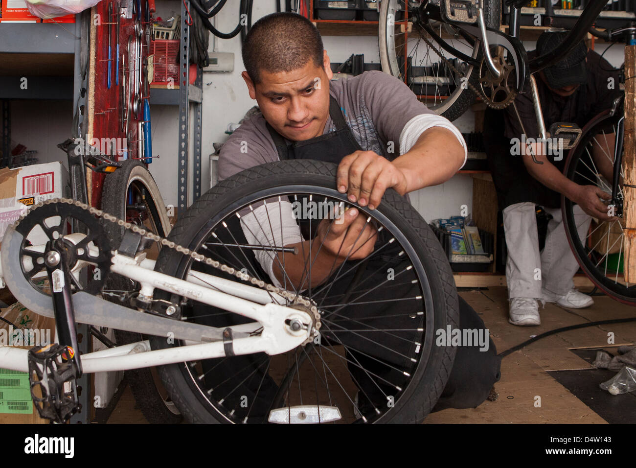 Mechanic working in bicycle shop Stock Photo - Alamy