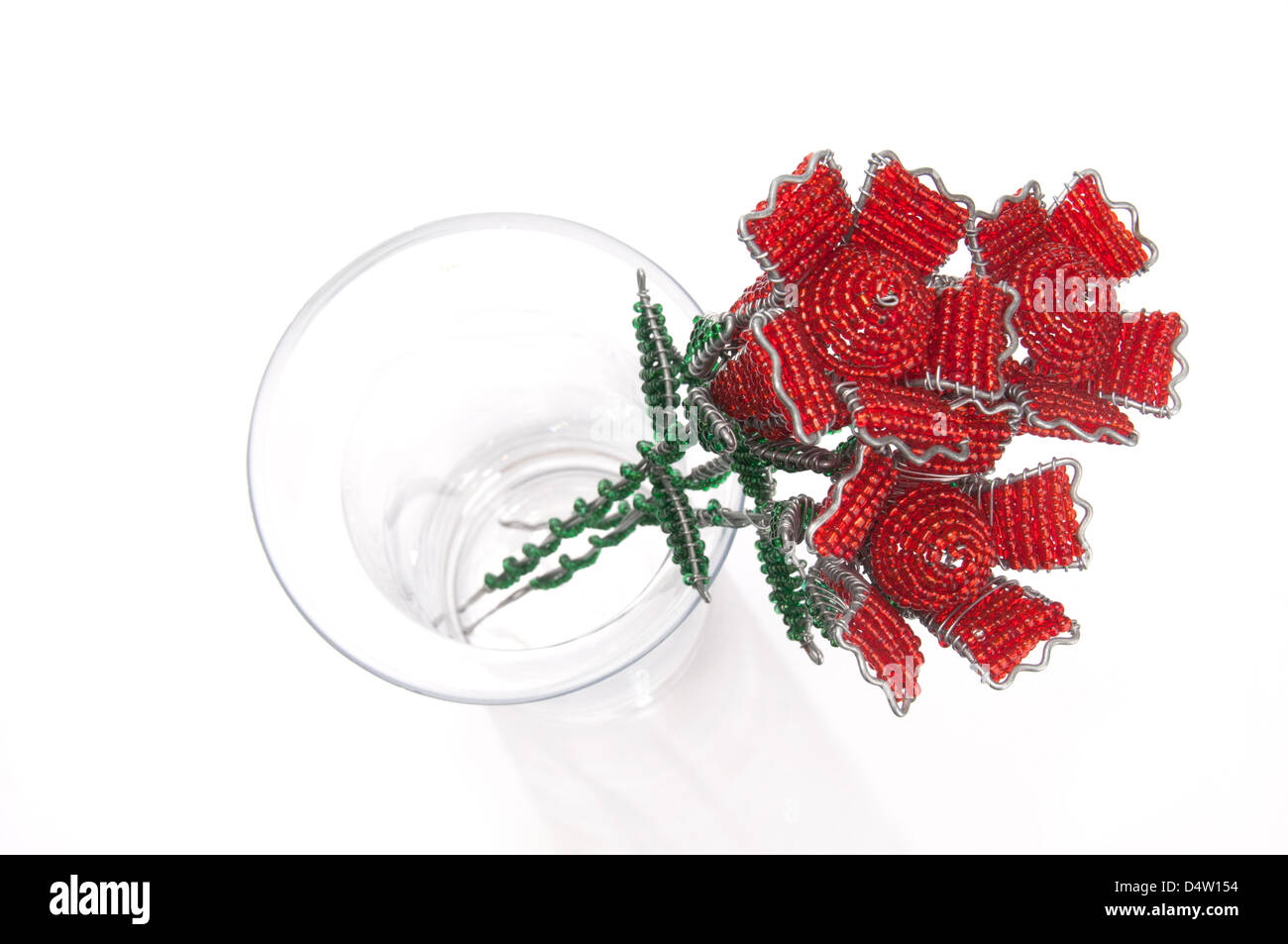 Three red beaded roses in a glass vase Stock Photo - Alamy