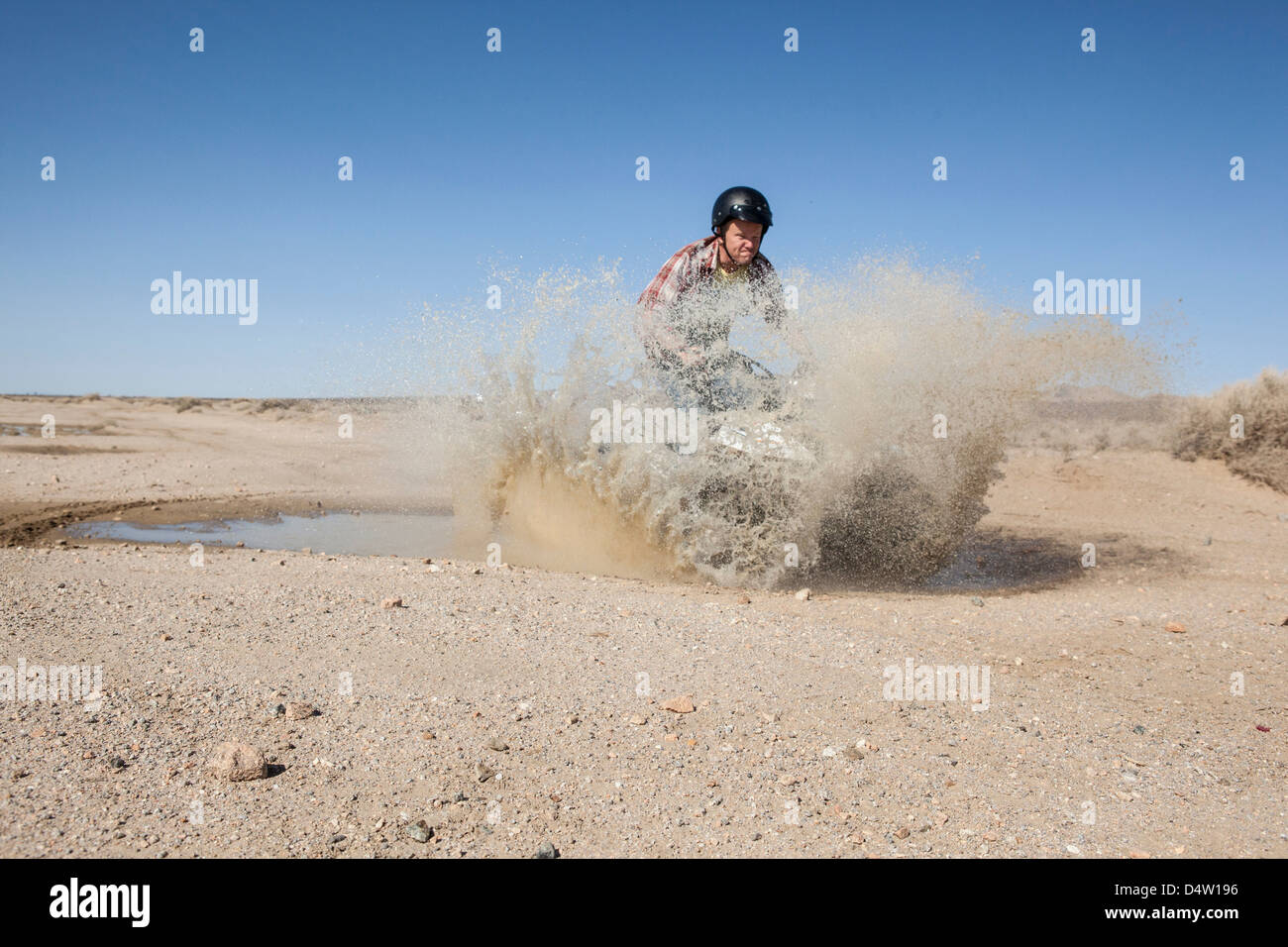 Man riding four-wheeler in desert Stock Photo - Alamy