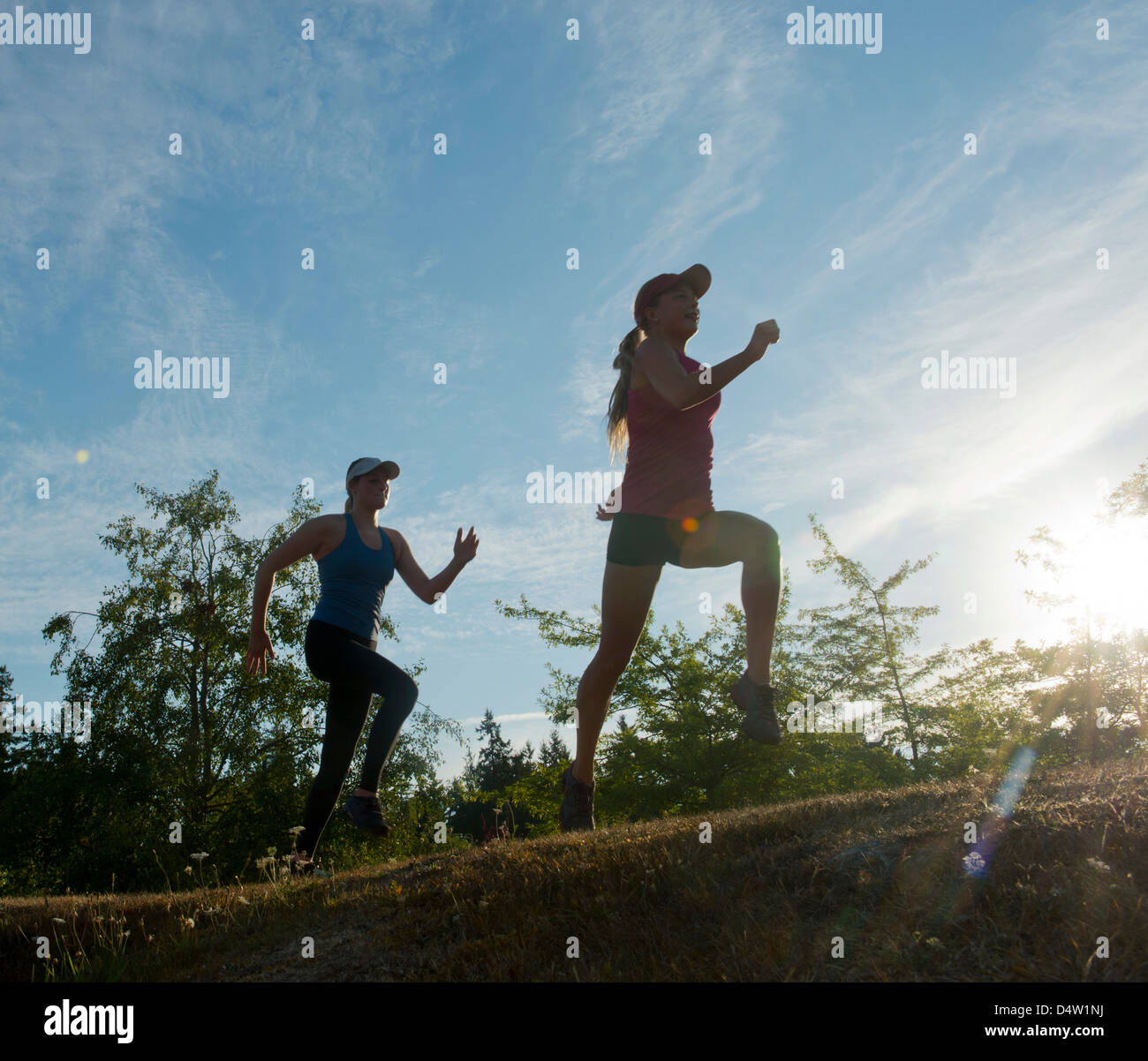 Two Girls In Silhouette Running High Resolution Stock Photography and ...