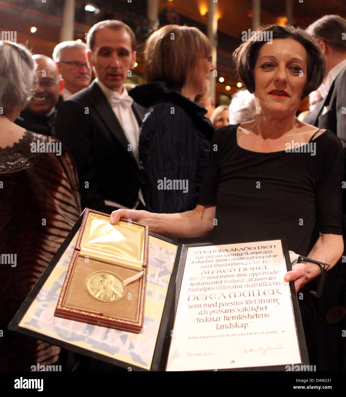 German writer Herta Mueller holds her prizeafter the awarding of the ...