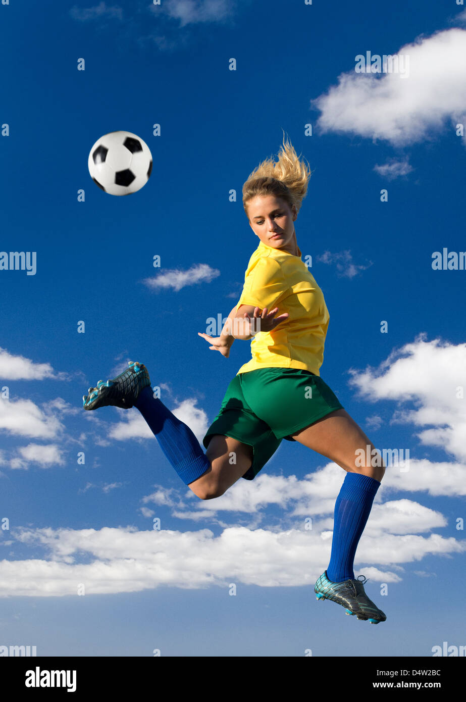 Soccer player kicking ball blue kit hi-res stock photography and images ...