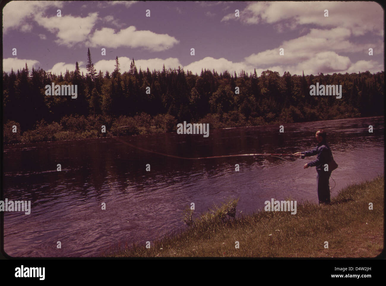 This 1973 photo shows people fishing in the Androscoggin River, located ...