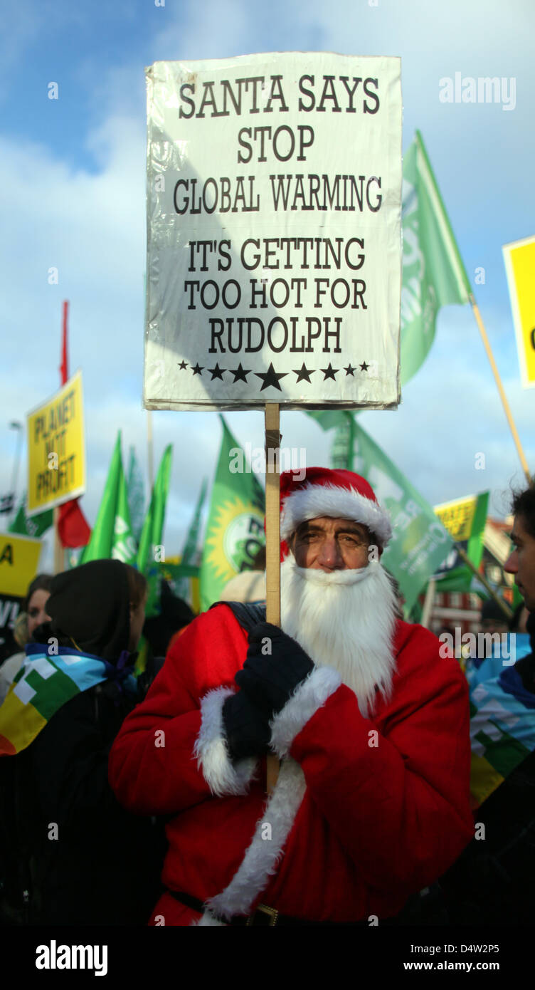 A man wears a Santa Claus costume while he demonstrates with tens of ...