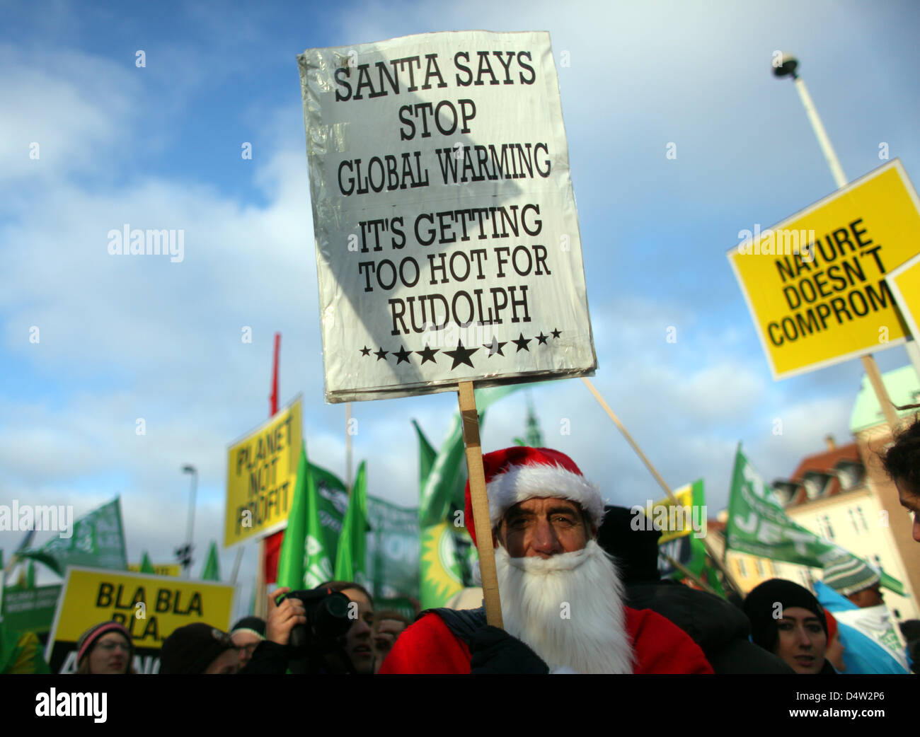 A man wears a Santa Claus costume while he demonstrates with tens of ...