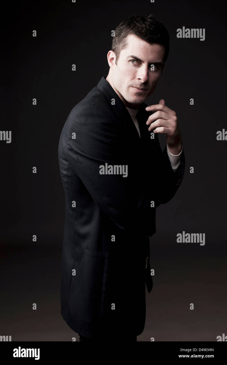 Serious man looking over his shoulder Stock Photo - Alamy