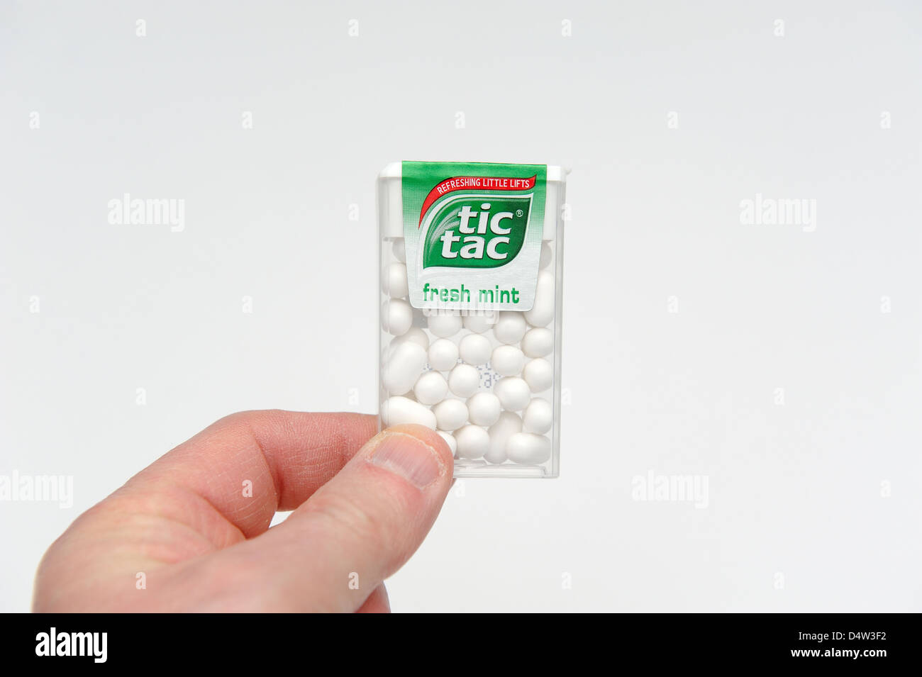 A person holding a pack of minty tic tacs Stock Photo - Alamy